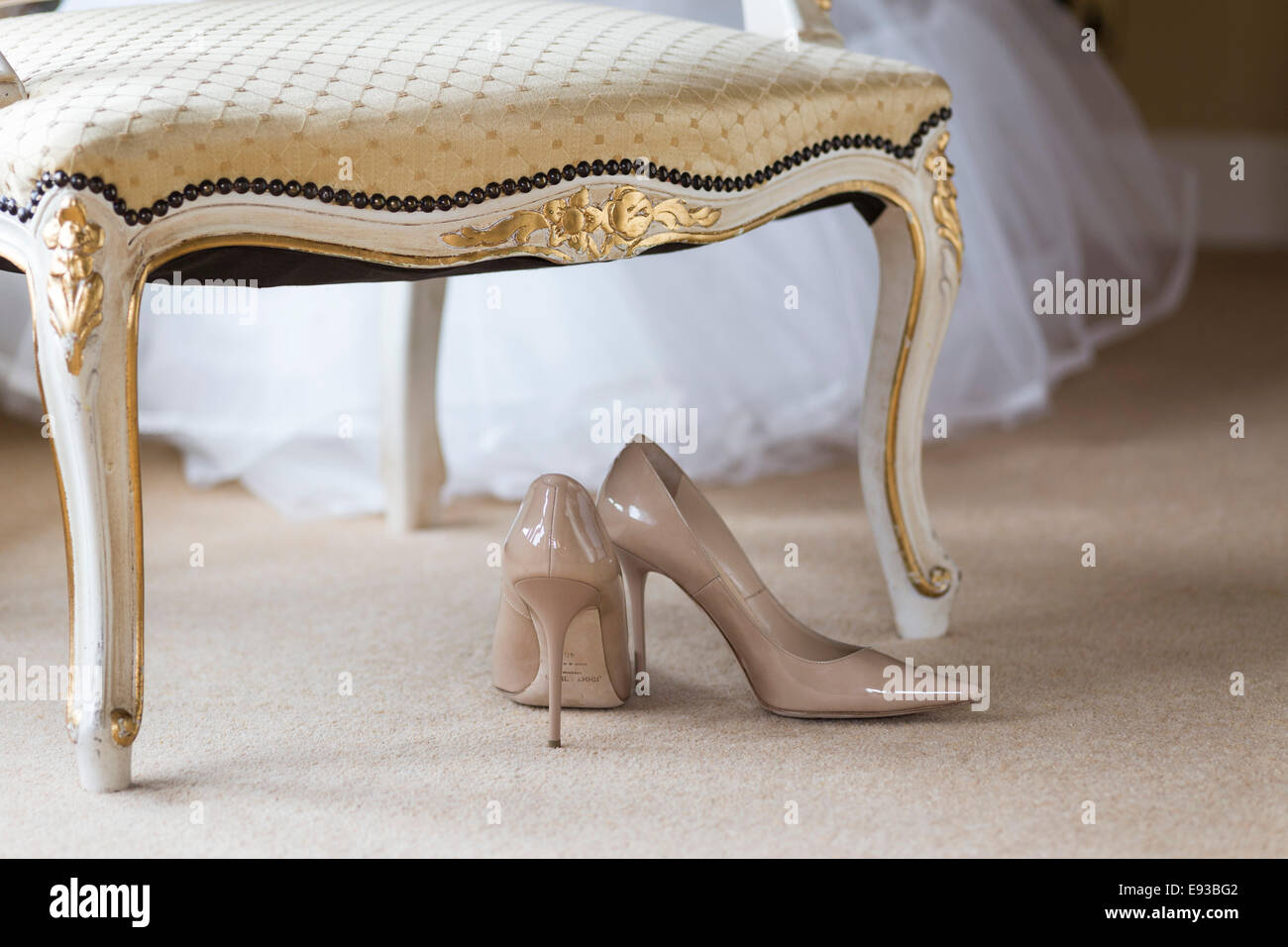 Wedding shoes beneath chair Stock Photo - Alamy