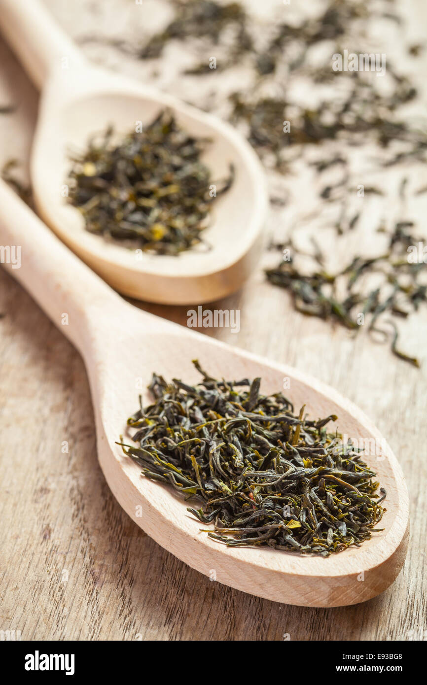 Wooden spoons with green tea herbs. Shallow DOF Stock Photo - Alamy