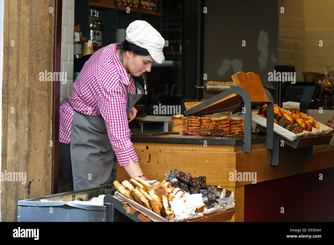 A small traditional bakery with a shop assistance in the City of Prague ...