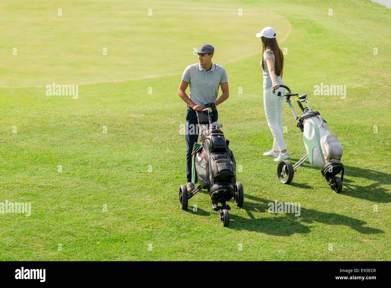 Young couple playing golf Stock Photo - Alamy