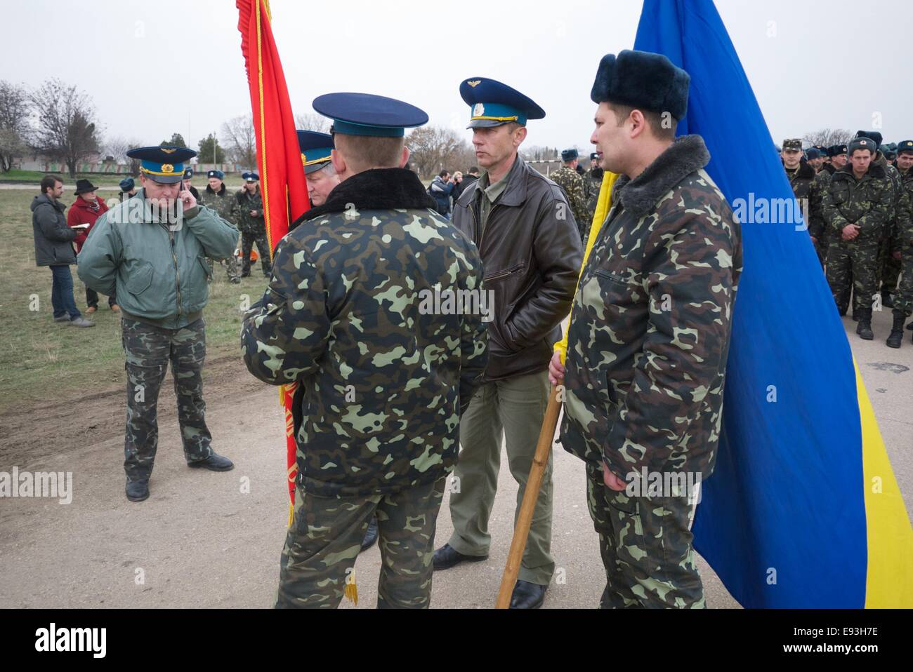 Colonel Yuli Manchur talks on his cell phone while airmen standby with ...
