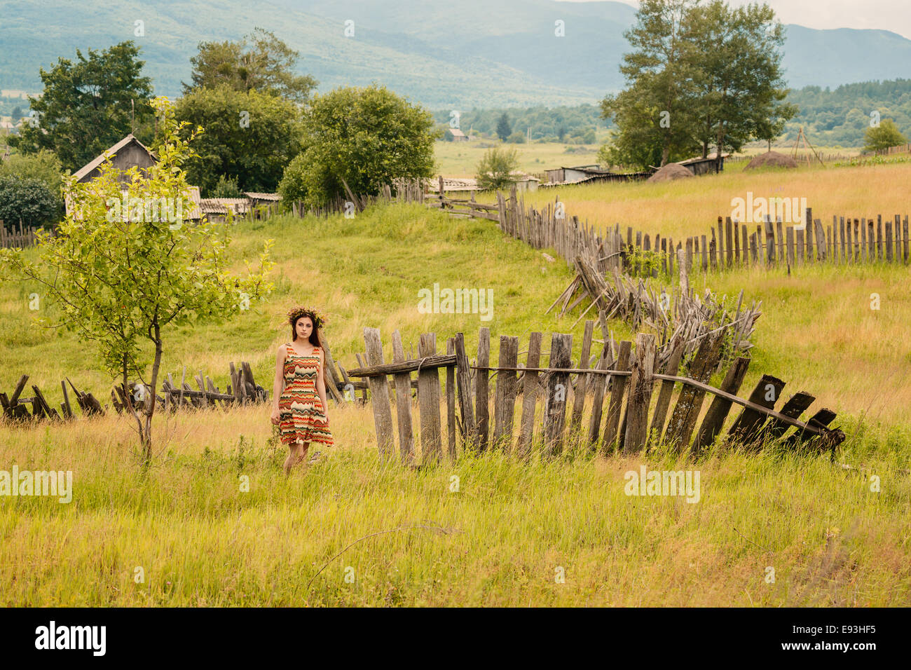 Woman walking in field Stock Photo - Alamy
