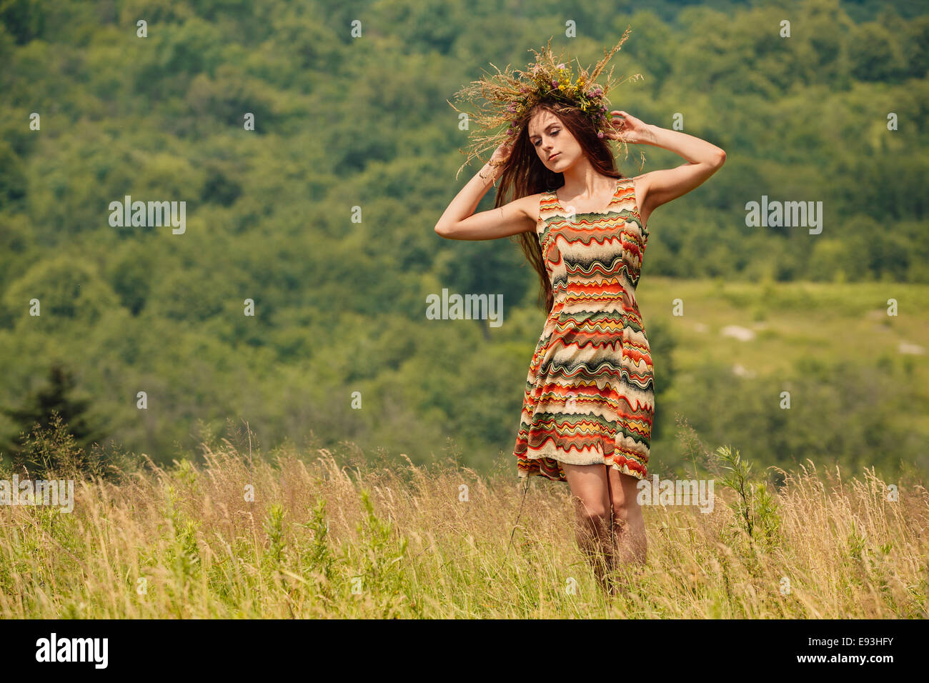 Woman walking in field Stock Photo - Alamy