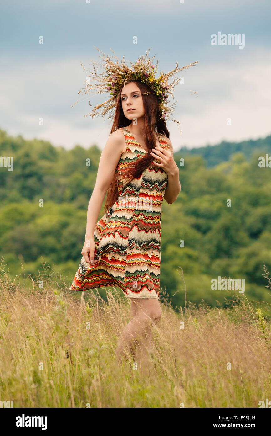 Woman walking in field Stock Photo - Alamy