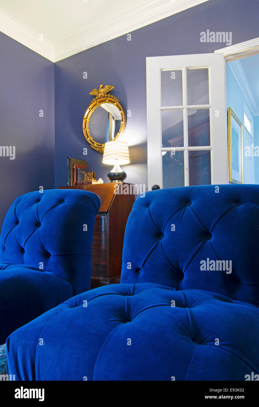 Living Room: A modern living room with blue chairs and a Federal period ...