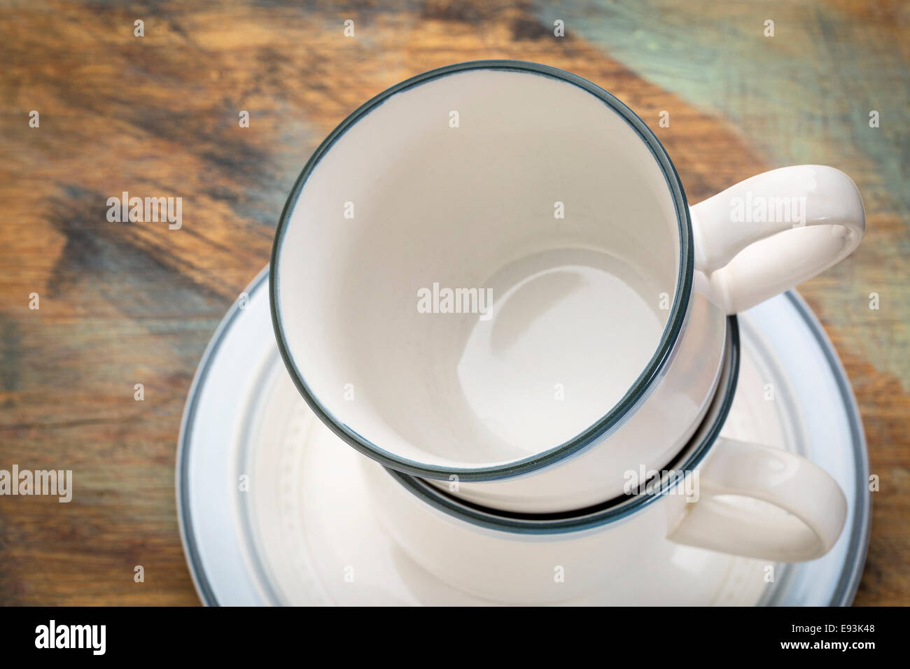 two empty stacked coffee cups on a grunge wood table, shallow depth of ...