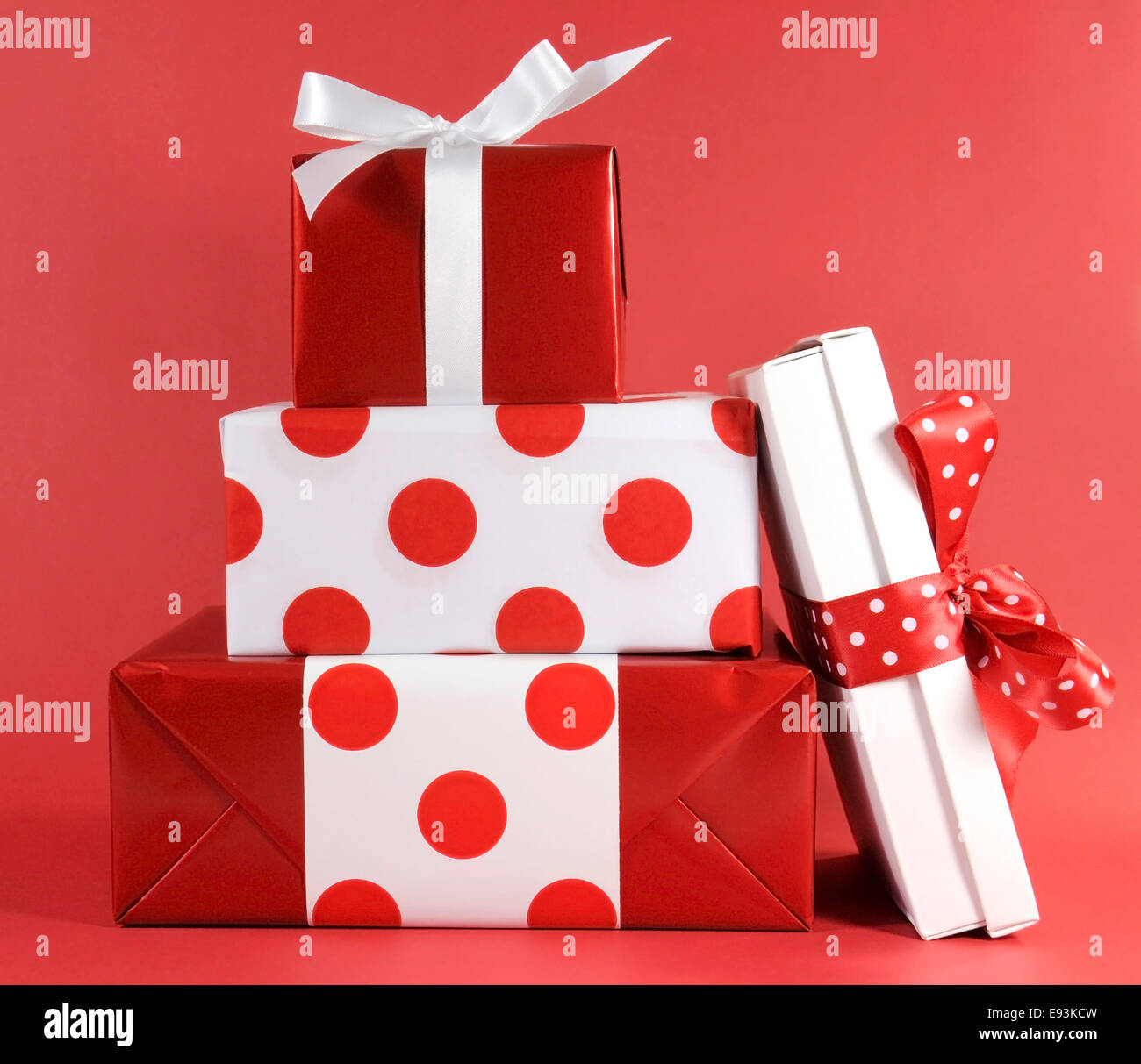 Stack of red and white polka dot theme festive gift box presents for ...