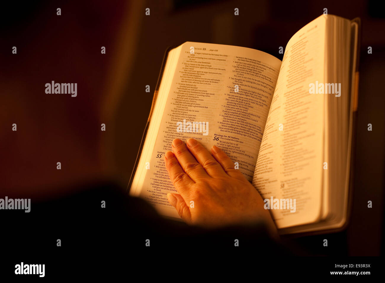 Woman with hand touching Bible Stock Photo - Alamy
