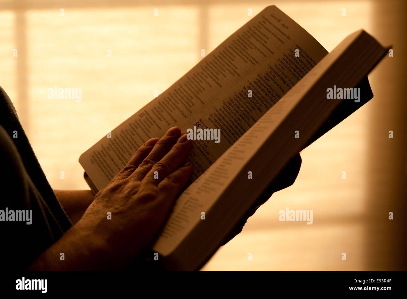Woman with hand touching Bible Stock Photo - Alamy