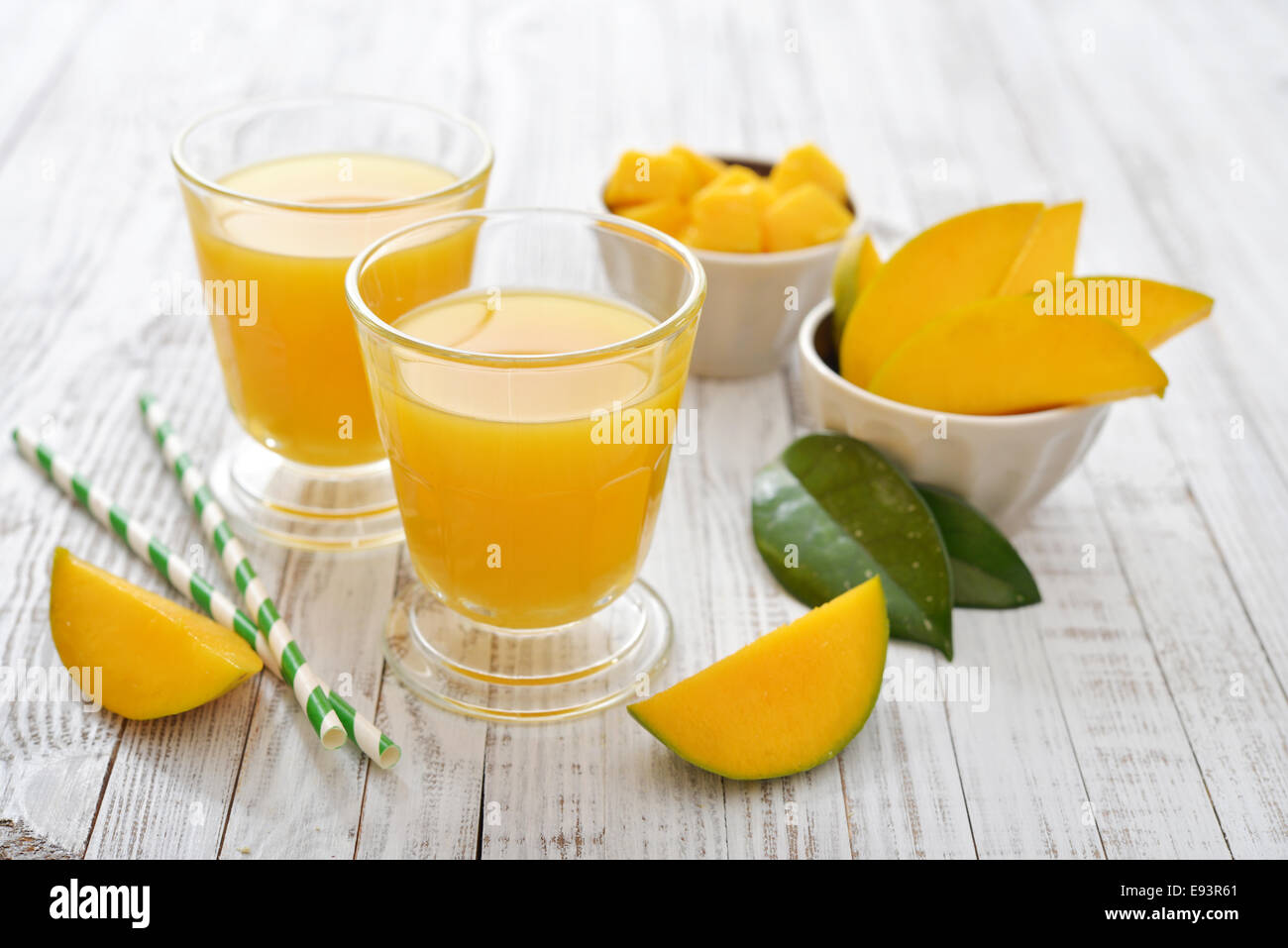 Mango juice in a glass on wooden white background Stock Photo - Alamy