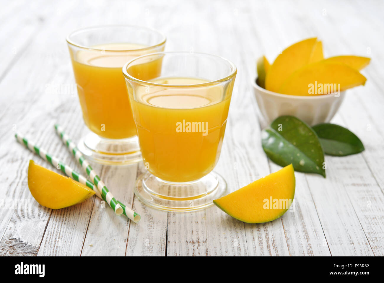 Mango juice in a glass on wooden white background Stock Photo - Alamy