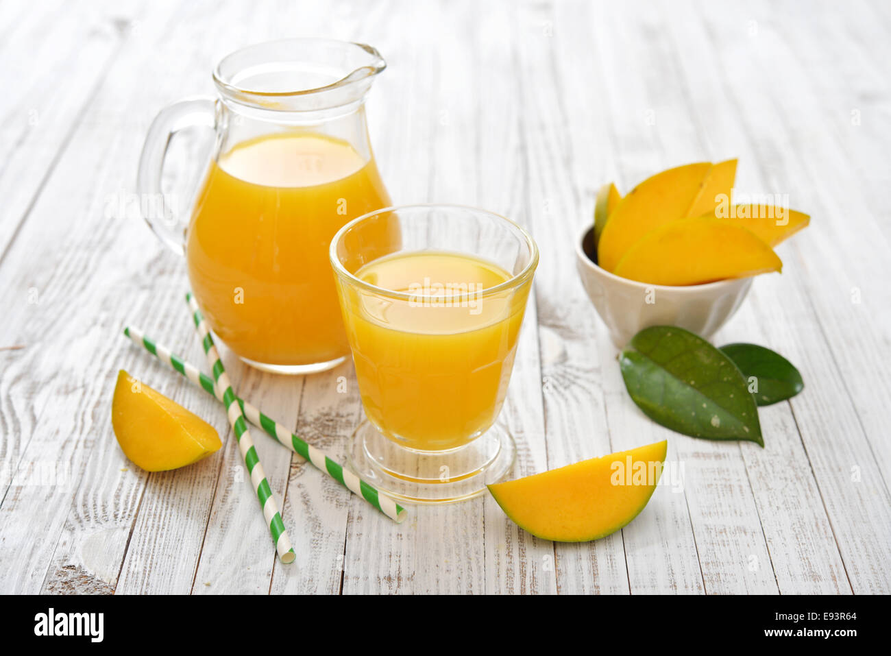 Mango juice in a glass on wooden white background Stock Photo - Alamy
