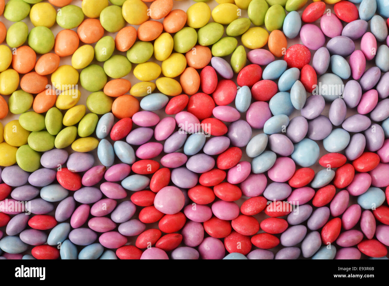 Sweet round multicolor candies spreading on background Stock Photo - Alamy