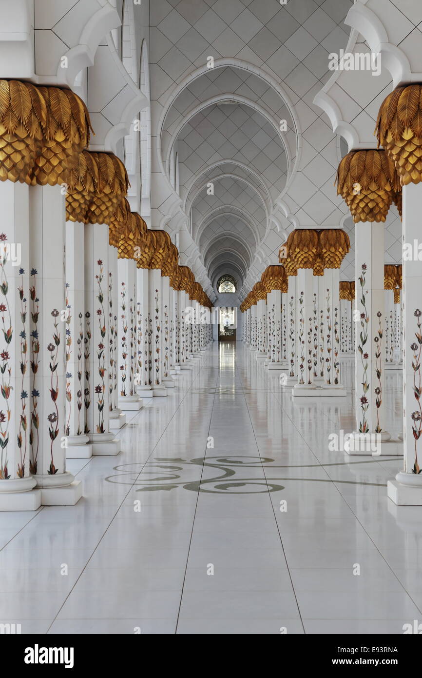 Arched corridor lined with pillars in the Sheikh Zayed Grand Mosque ...