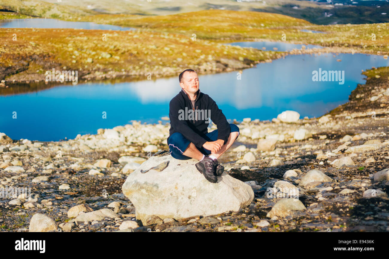 Man sit on stone hi-res stock photography and images - Alamy