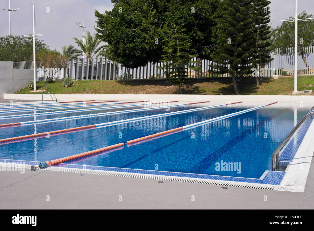 Outdoor swimming pool in Spain with palms and blue water Stock Photo ...
