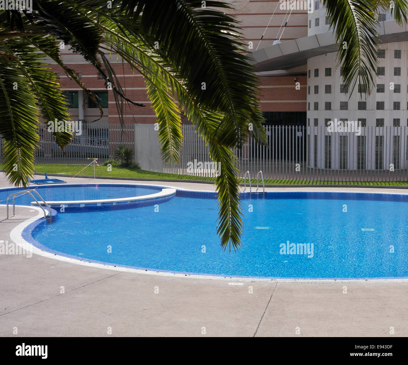 Outdoor swimming pool in Spain with palms and blue water Stock Photo ...