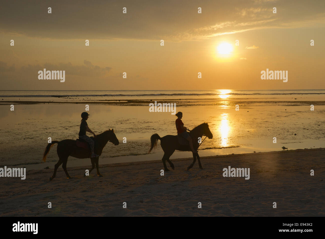 Horse riding on beach at sunset hi-res stock photography and images - Alamy