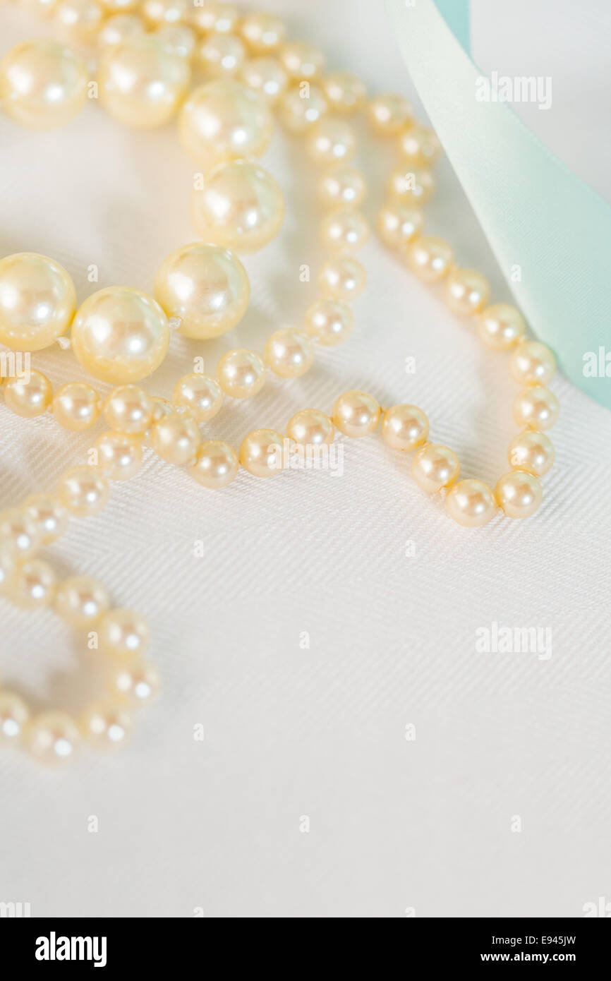 White vintage pearls on the table Stock Photo - Alamy