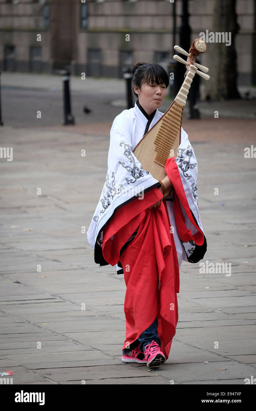 Women in traditional Chinese costume carrying traditional instrument ...