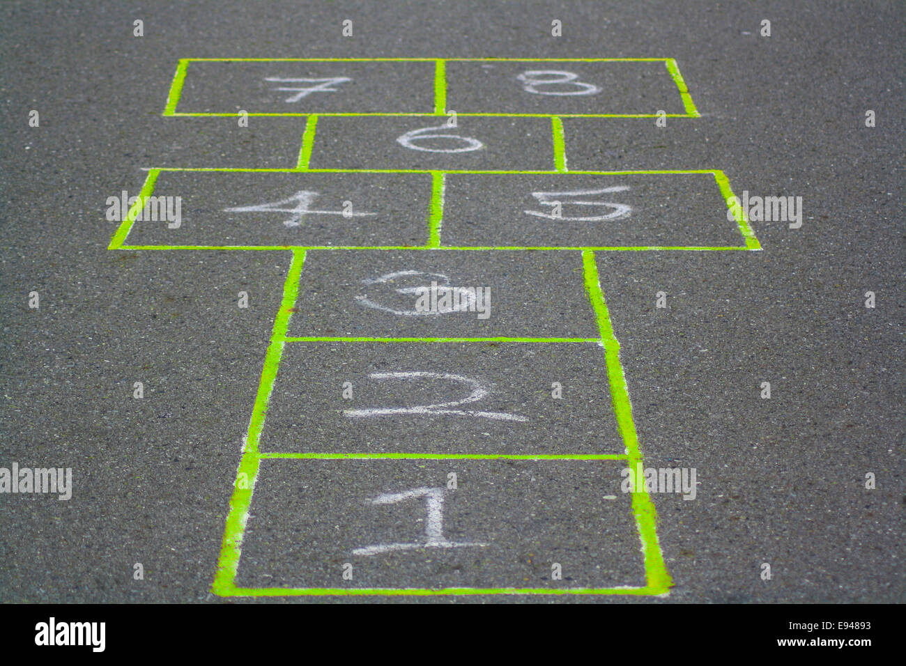 hopscotch painted on pavement childs game in yellow with numbers Stock ...