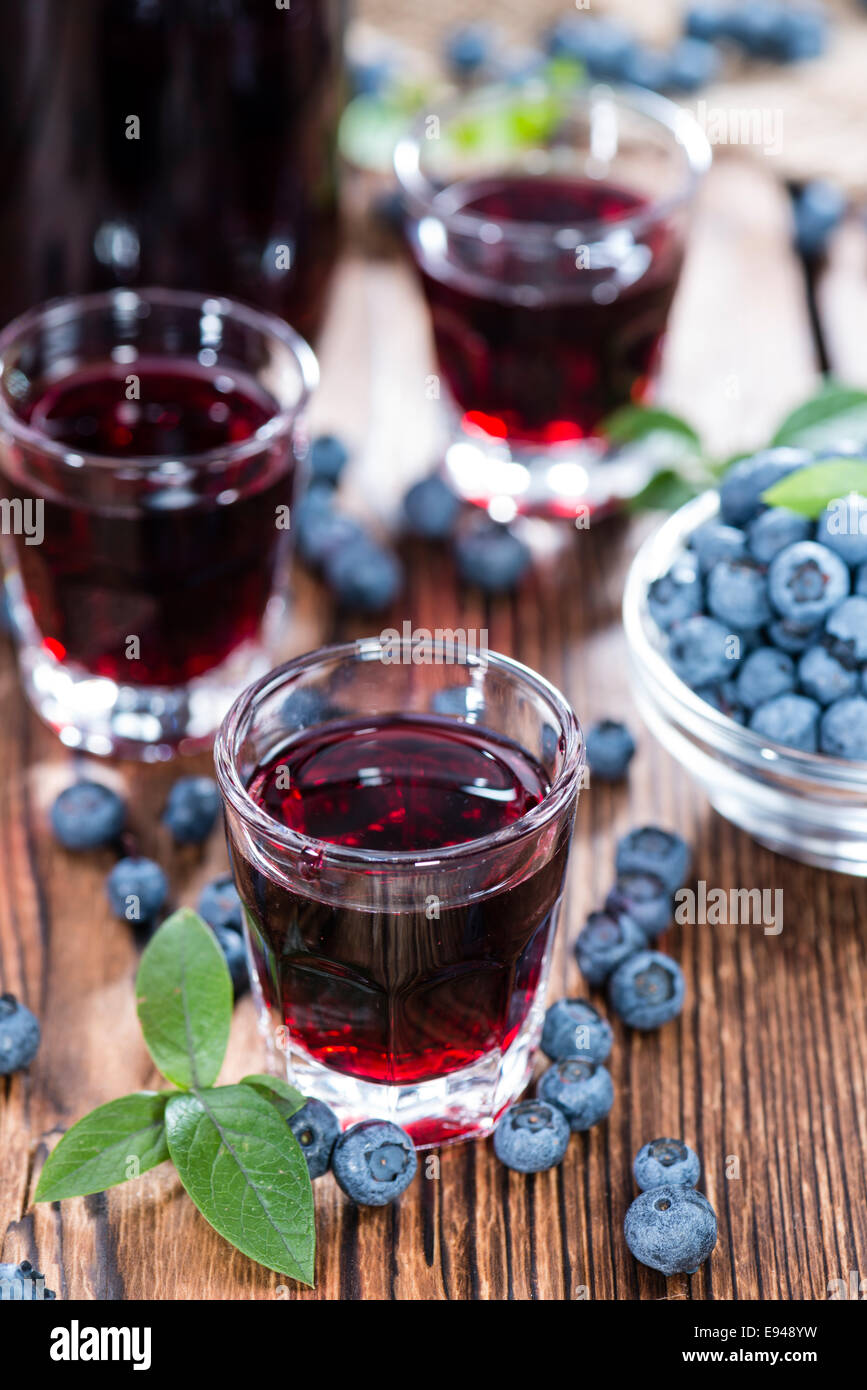 Blueberry Liqueur with some fresh fruits in a small glass Stock Photo ...