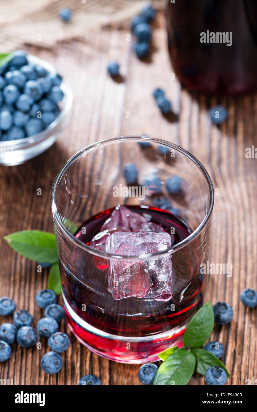 Homemade Blueberry Liqueur with fresh fruits on wooden background Stock ...
