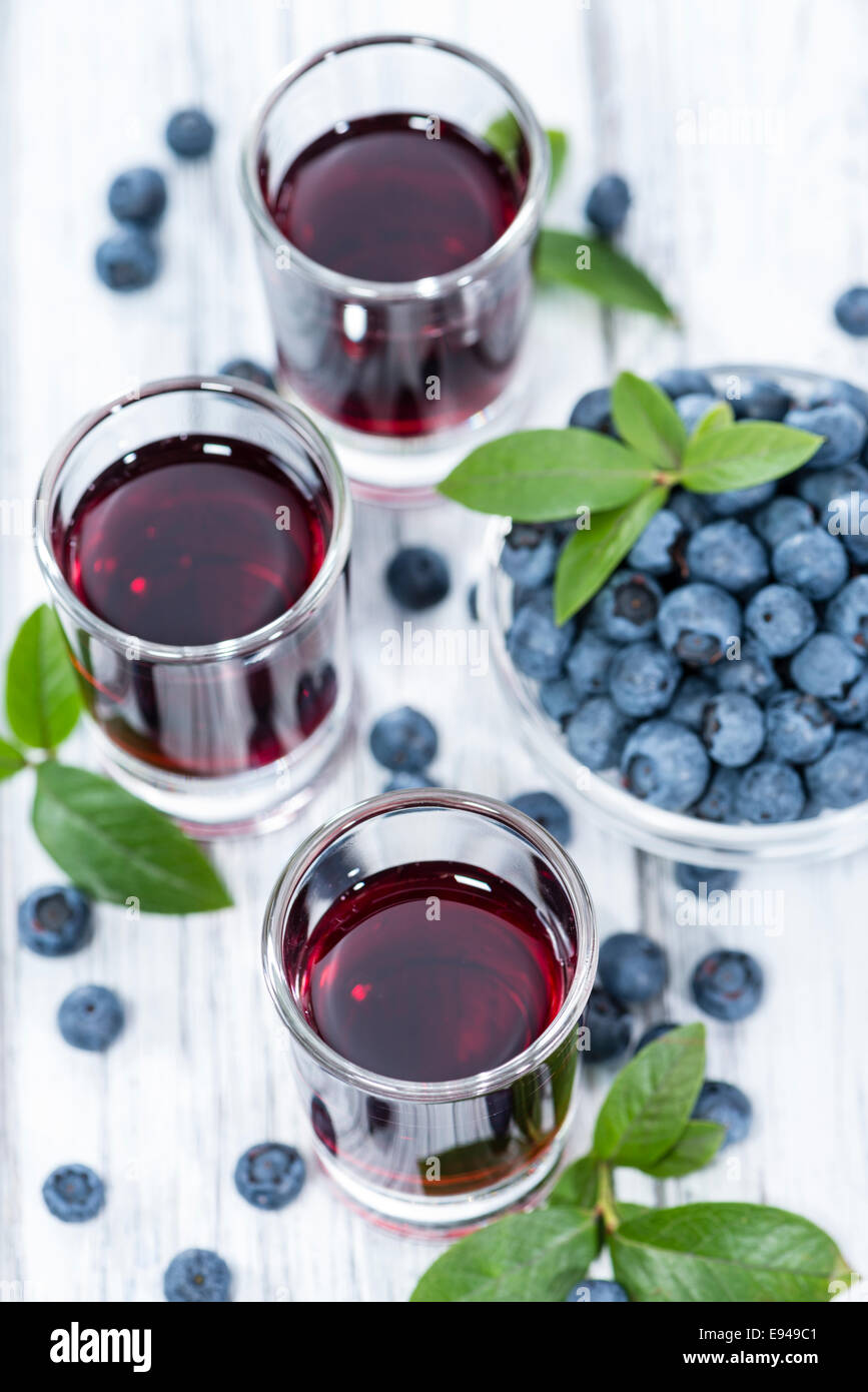 Blueberry Liqueur with some fresh fruits in a small glass Stock Photo ...