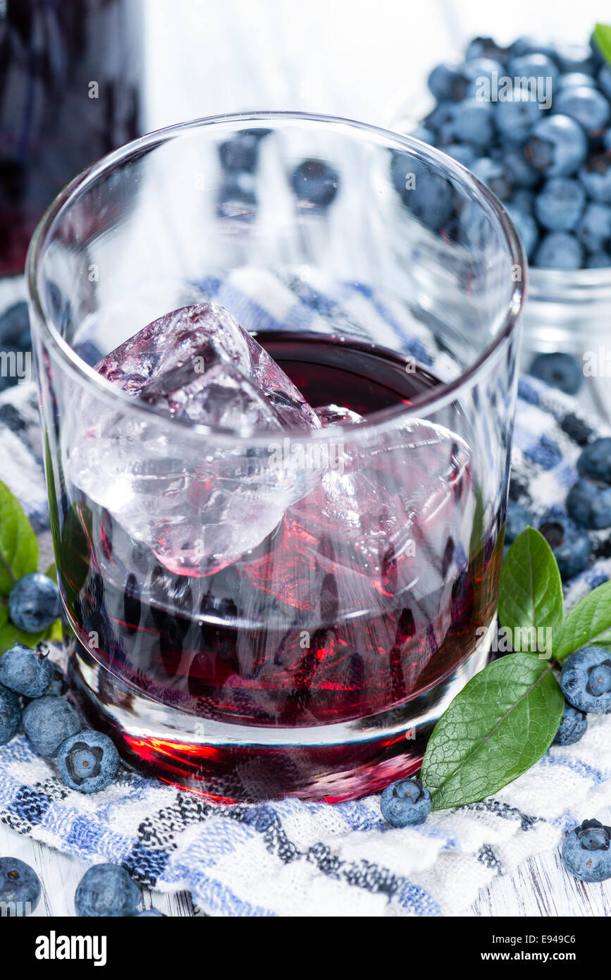 Blueberry Liqueur with some fresh fruits in a small glass Stock Photo ...
