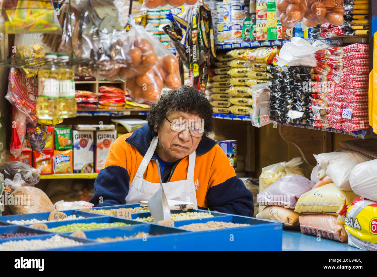 Local old Peruvian woman stallholder attending at a typical small ...