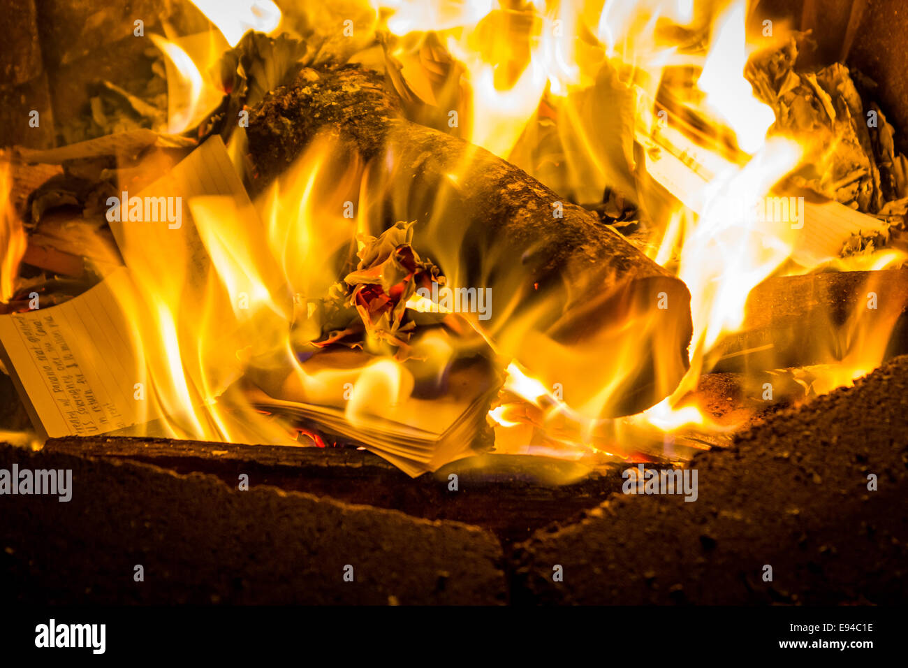 Paper slowly burning in a campfire Stock Photo - Alamy