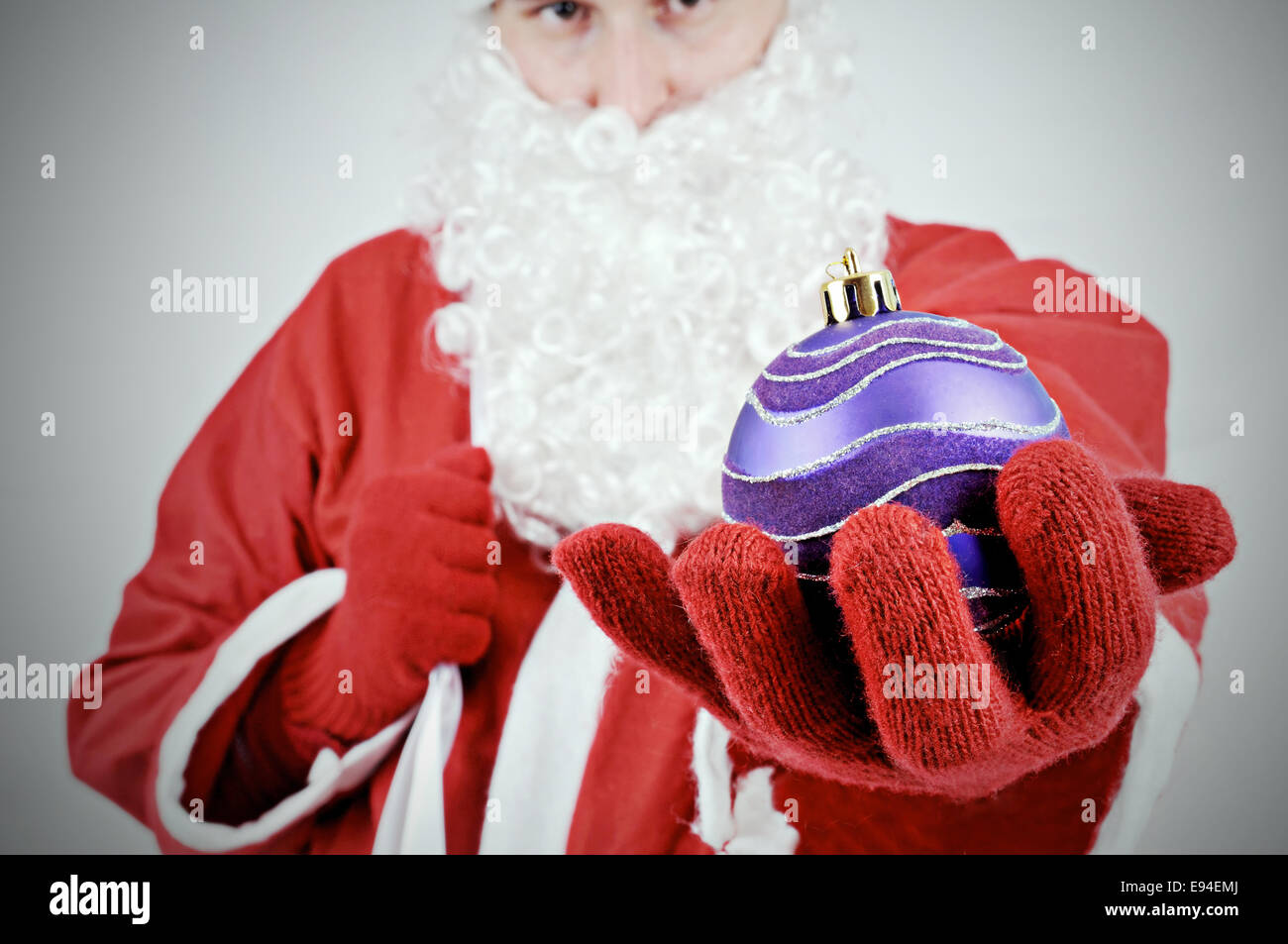 Santa Clause Showing christmas ball Stock Photo - Alamy