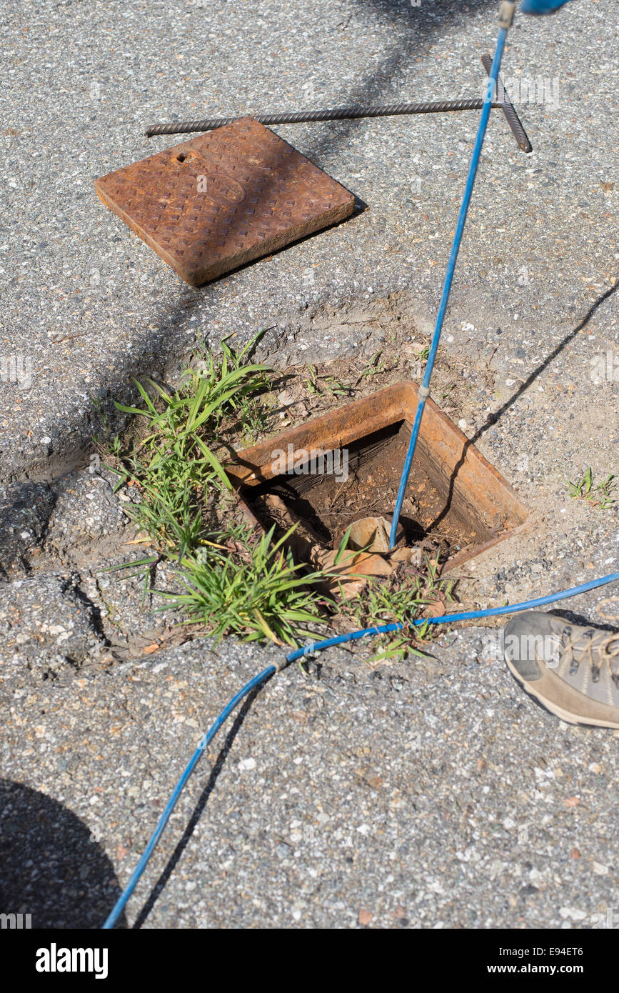 Geologist taking inclinometer readings on road, measuring slope ...