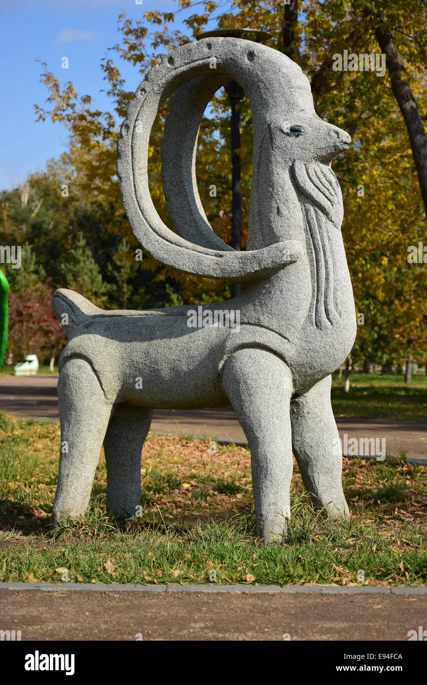 Stone statue featuring a mythological mountain goat in a park in Astana ...