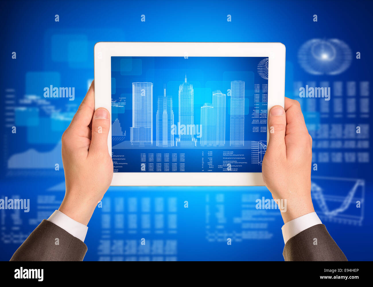 Man hands using tablet pc. Image of wire-frame buildings on screen ...