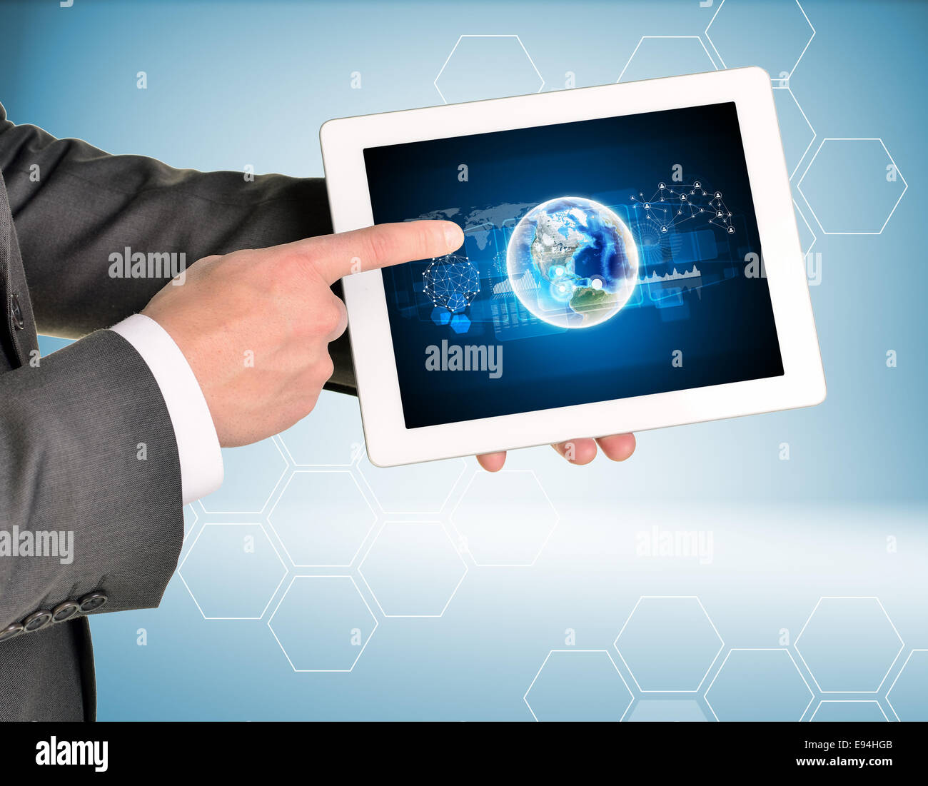 Man hands using tablet pc. Image of Earth on screen Stock Photo - Alamy