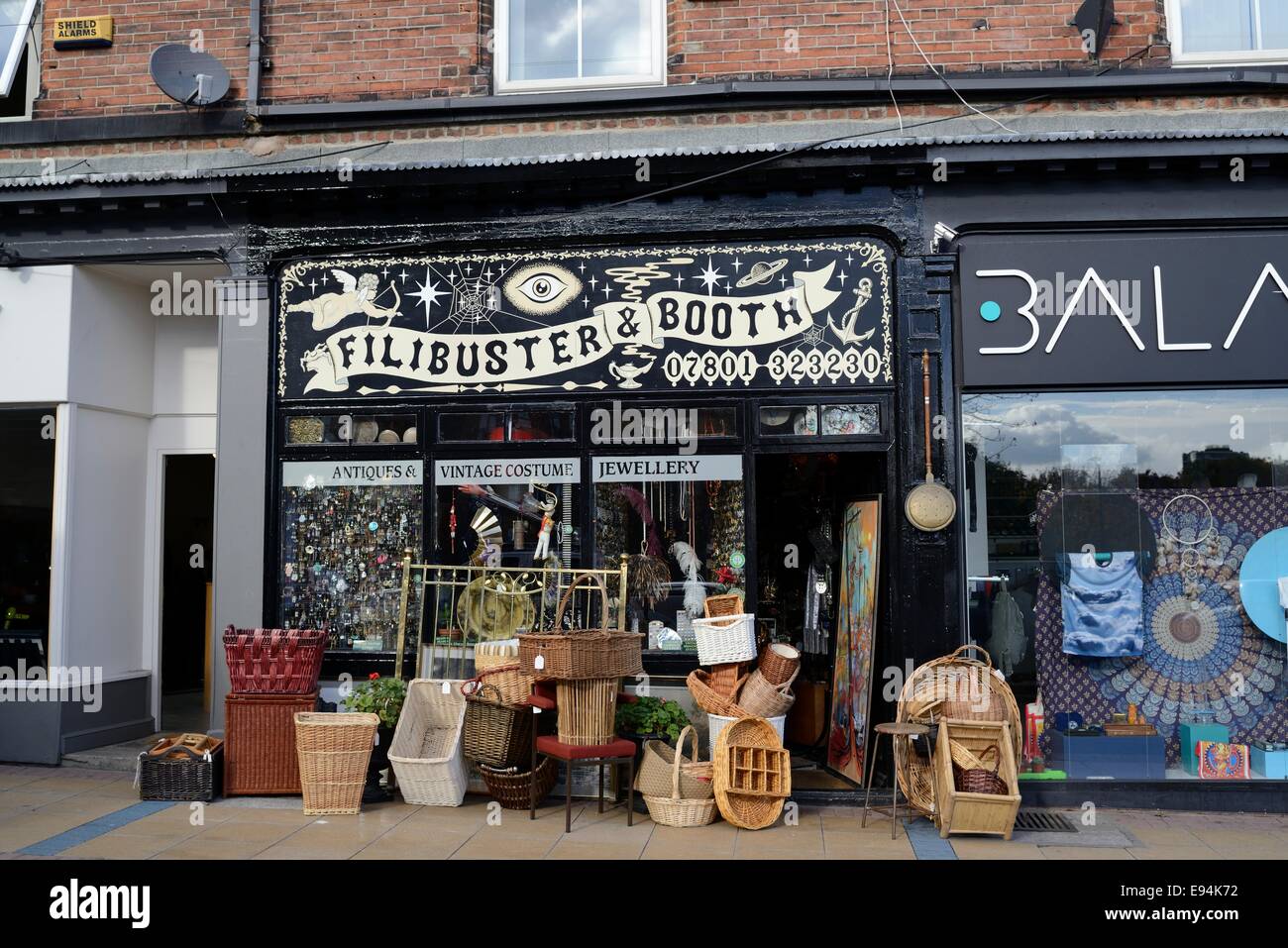 Brightly decorated antique shop with display of baskets outside Stock ...