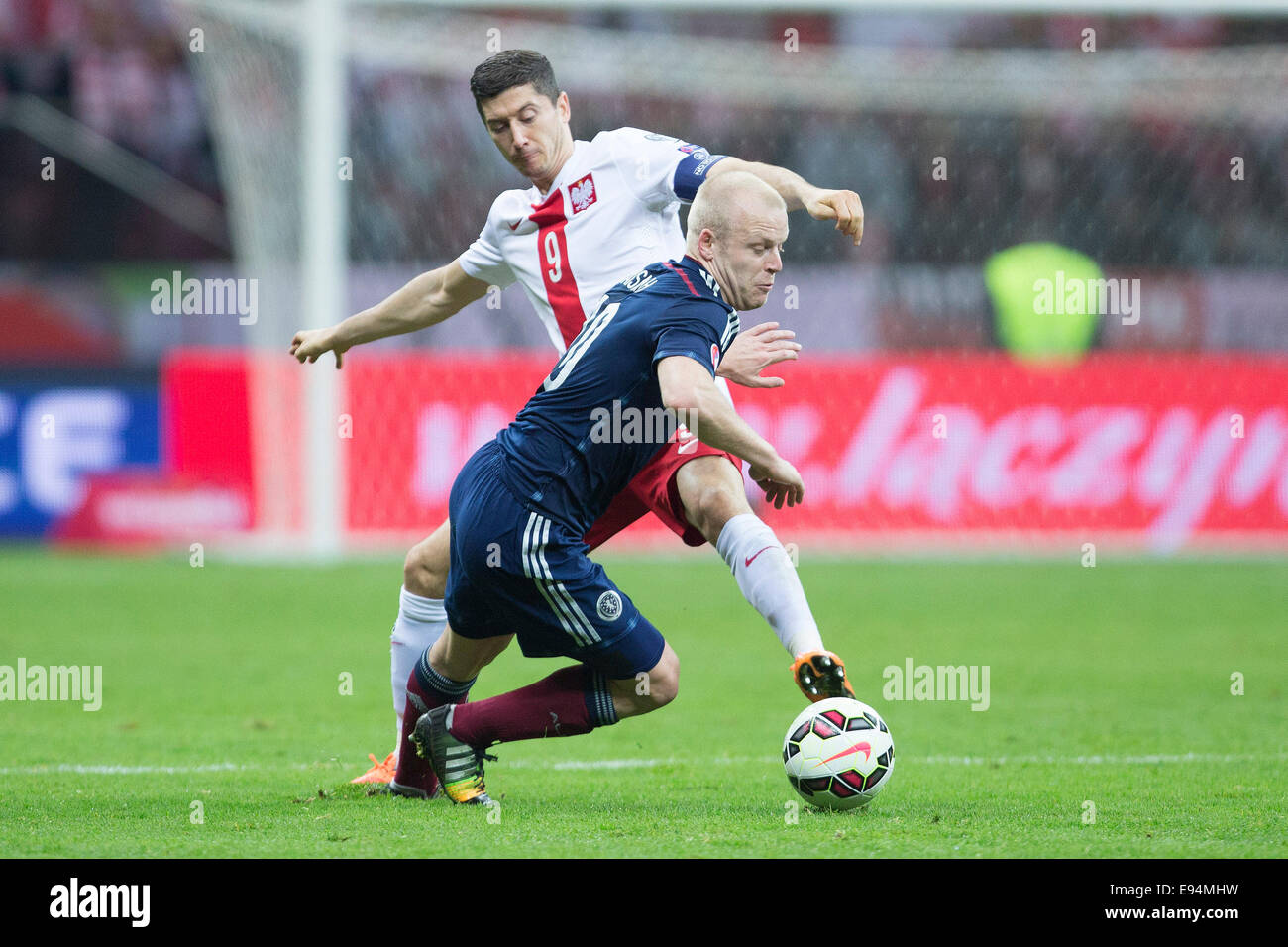 Warsaw, UK. 14th Oct, 2014. Robert Lewandowski of Poland tackles Steven ...