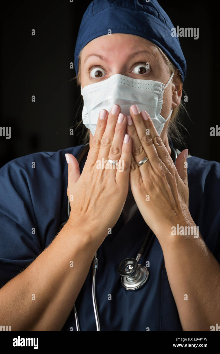 Shocked Looking Female Doctor or Nurse with Hands in Front of Mouth ...