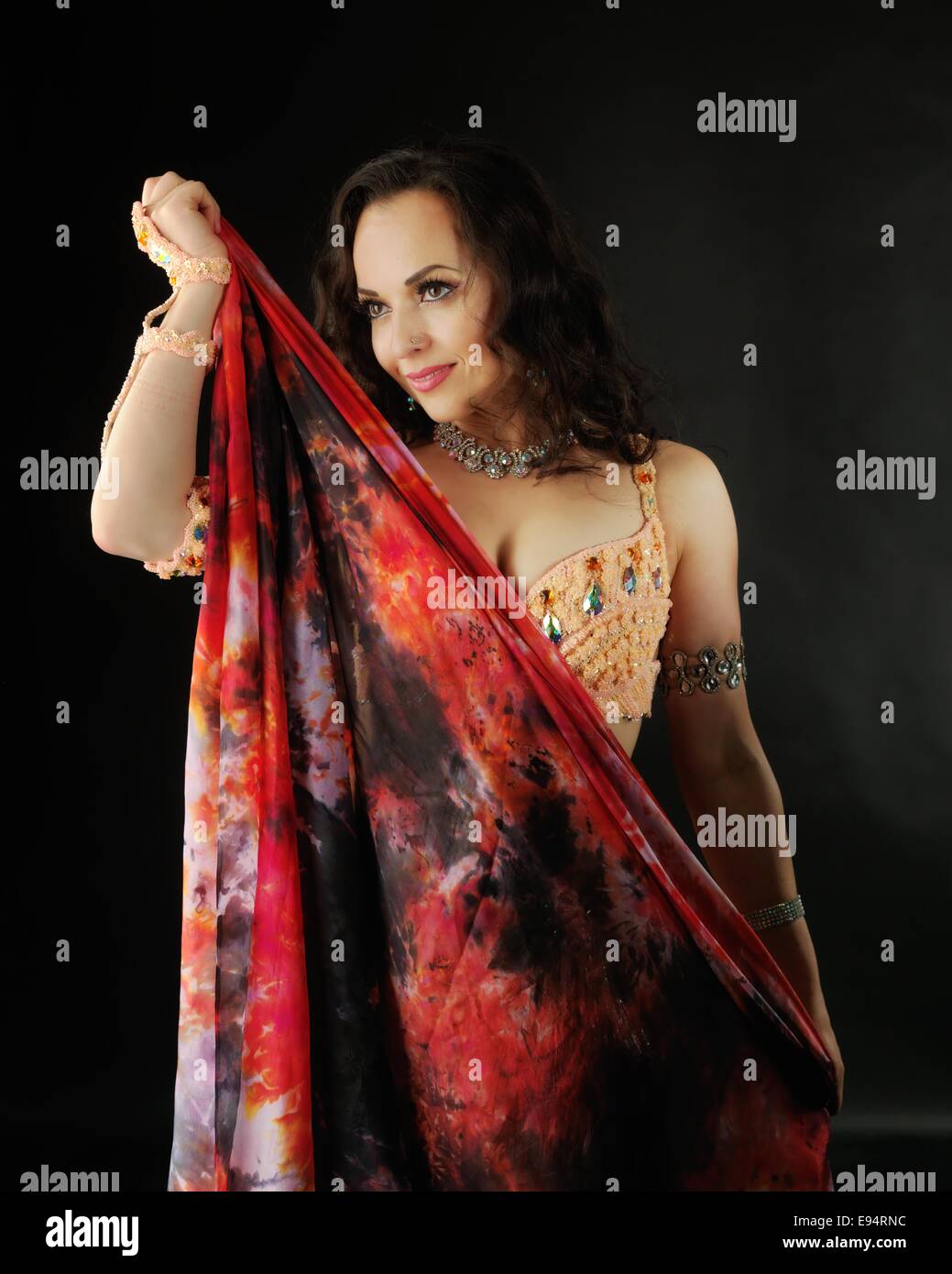 Young beautiful belly dancer wearing a colorful costume in front of the ...