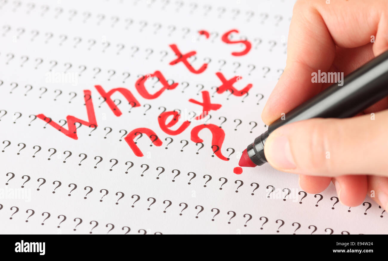 Woman's hand with red pen writing words "What's next?" on the ...