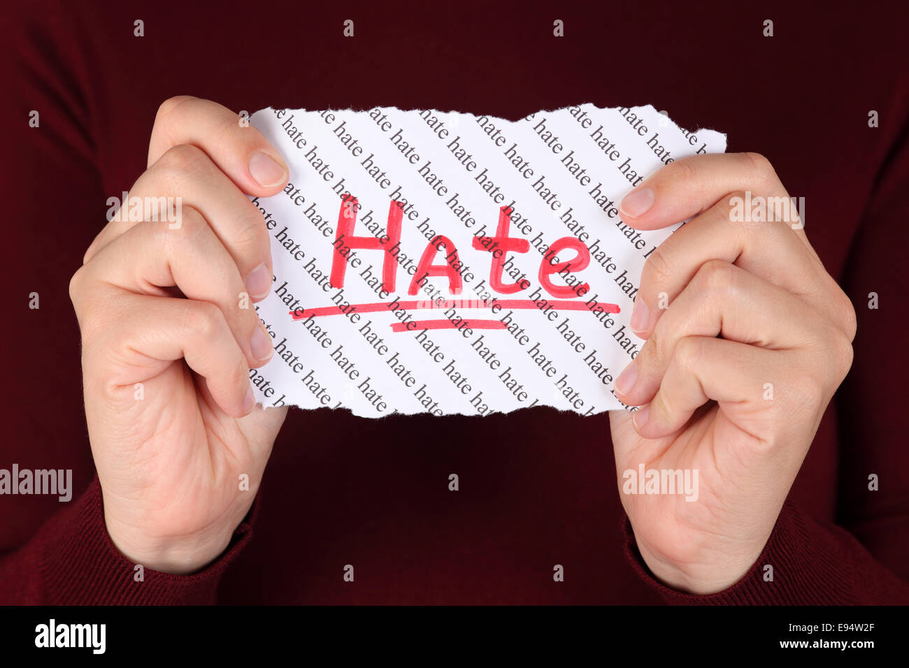 Piece of paper with red word "Hate" in the woman's hands Stock Photo ...