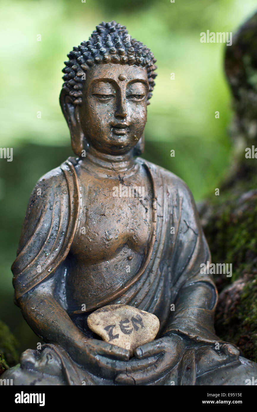 Buddha statue meditating in yoga pose Stock Photo - Alamy