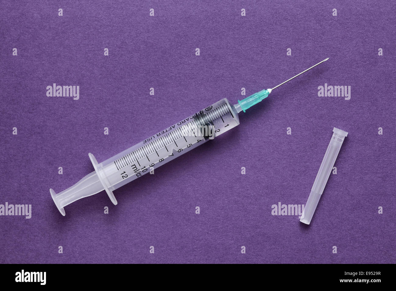 Purple background and syringe. Close-up Stock Photo - Alamy