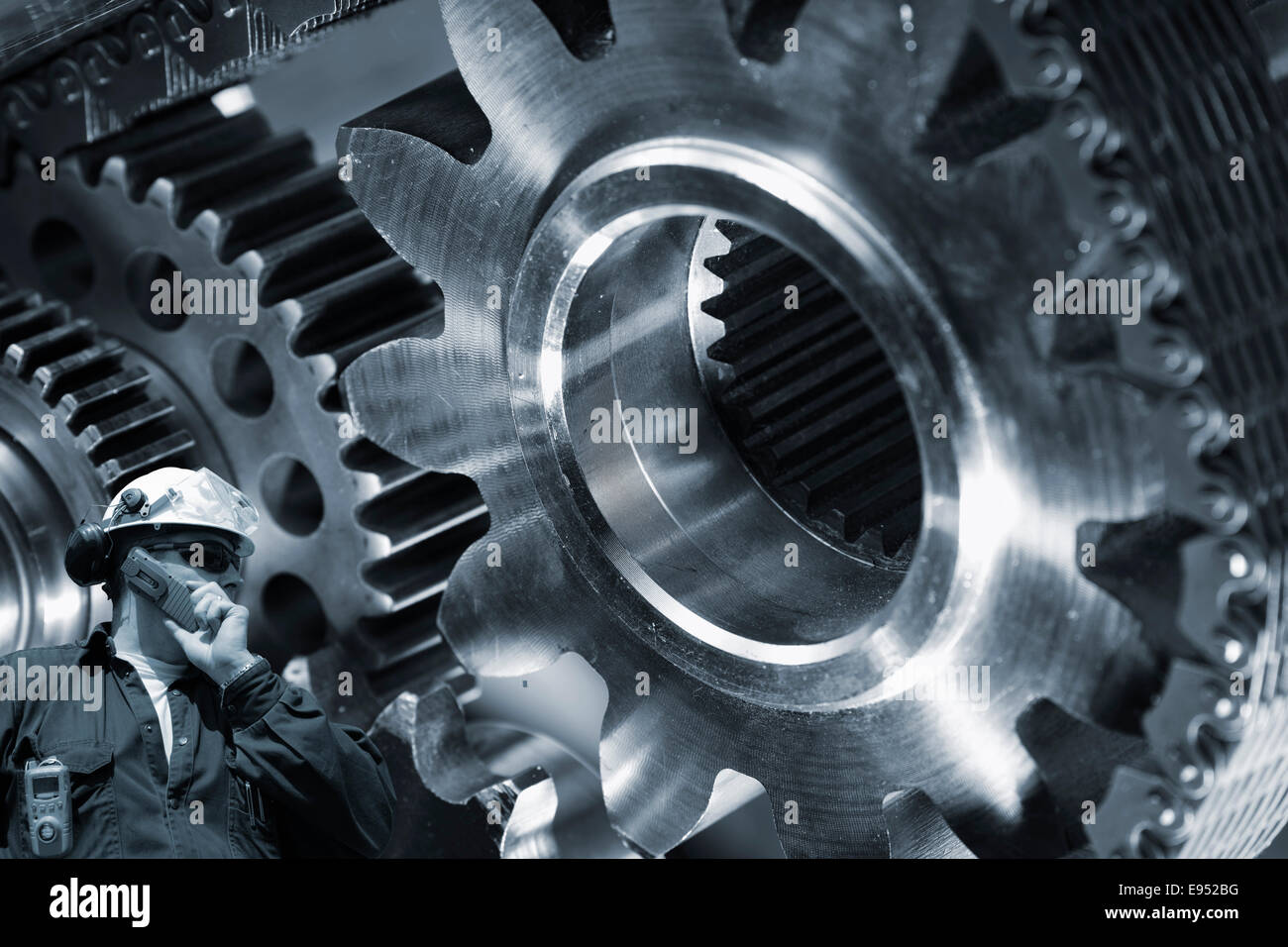 cogwheels and gears machinery with mechanics Stock Photo - Alamy