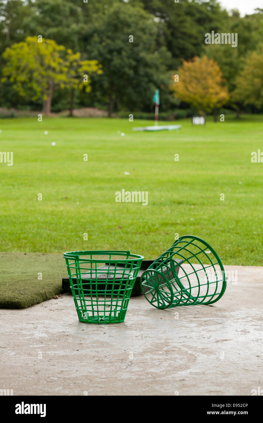 Two Empty Golf Ball Baskets at Driving Range with Hole and Flag in ...