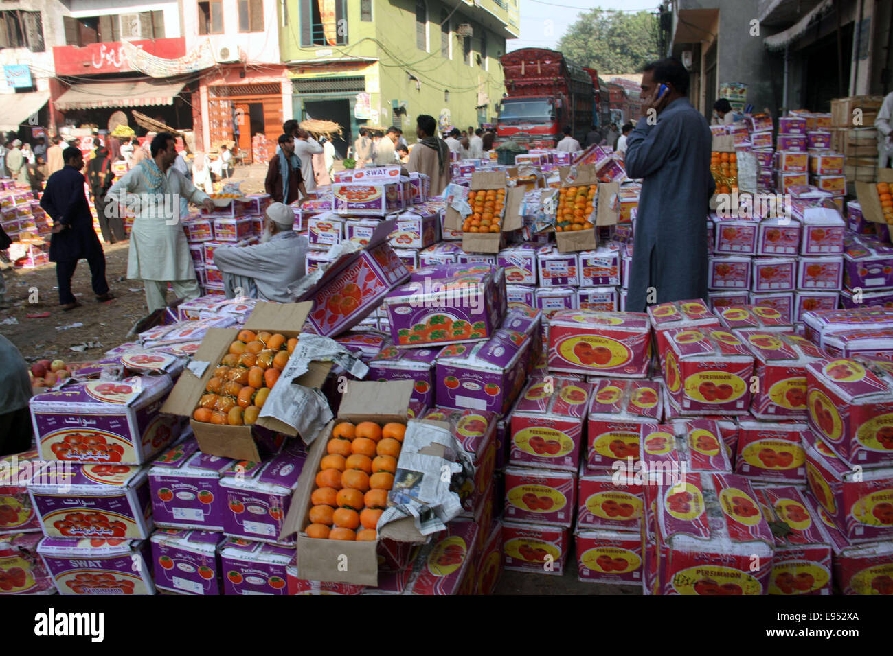 Lahore. 20th Oct, 2014. Pakistani fruit vendors wait for customers at a ...