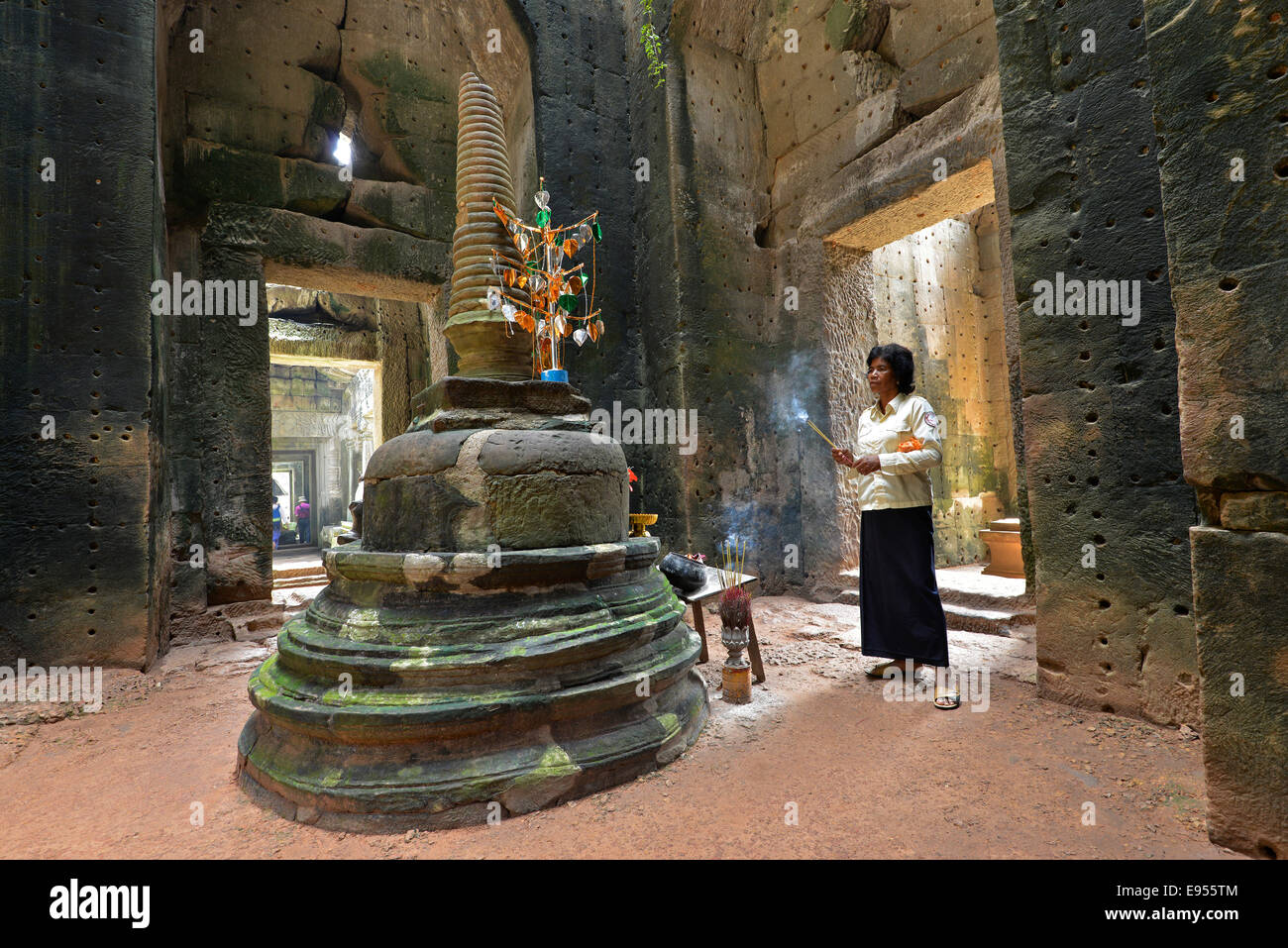 Cambodian with incense sticks in front of Stupa, Preah Khan, Angkor Wat ...