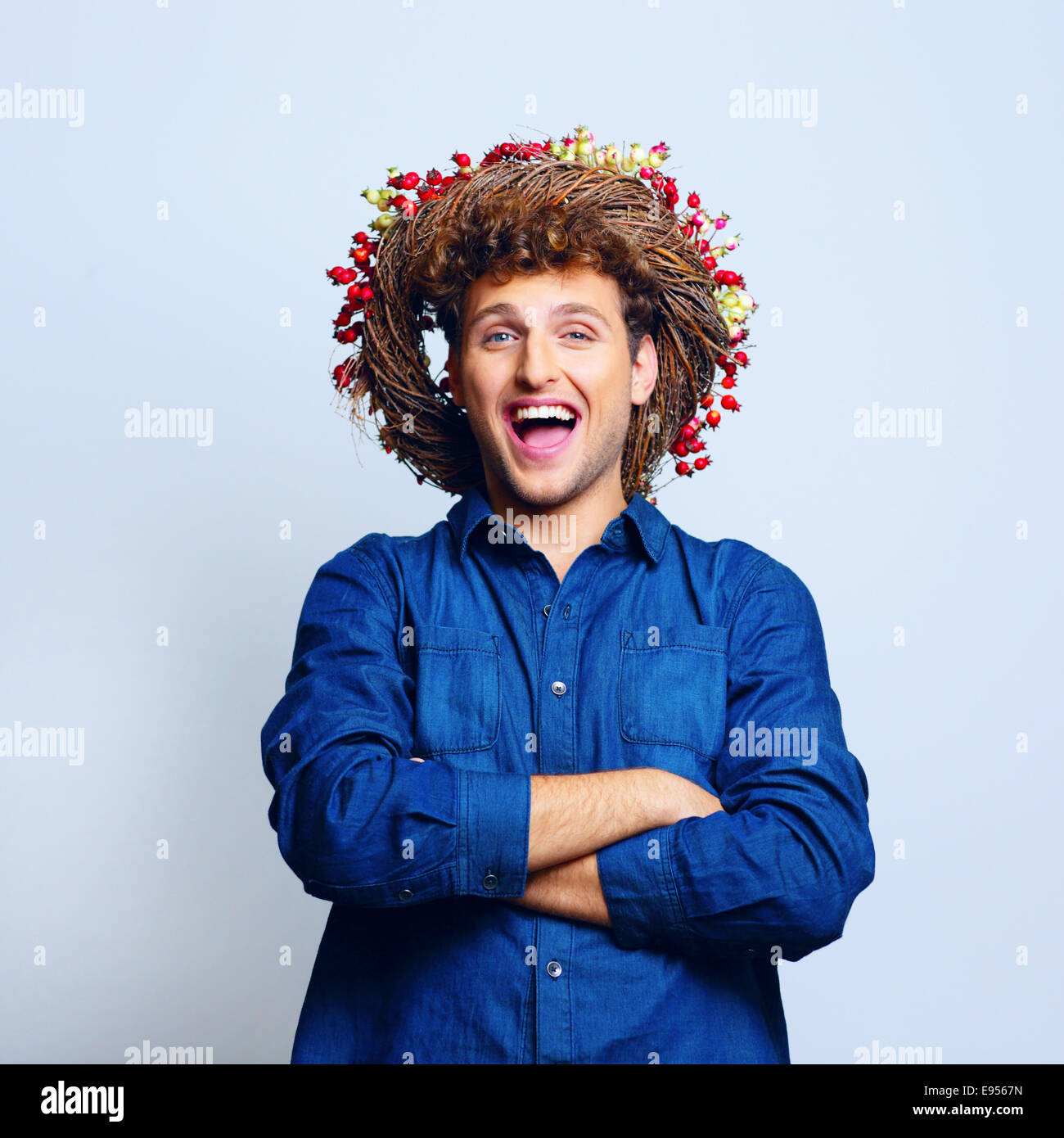 Portrait of a laughing funny man with wreath Stock Photo - Alamy
