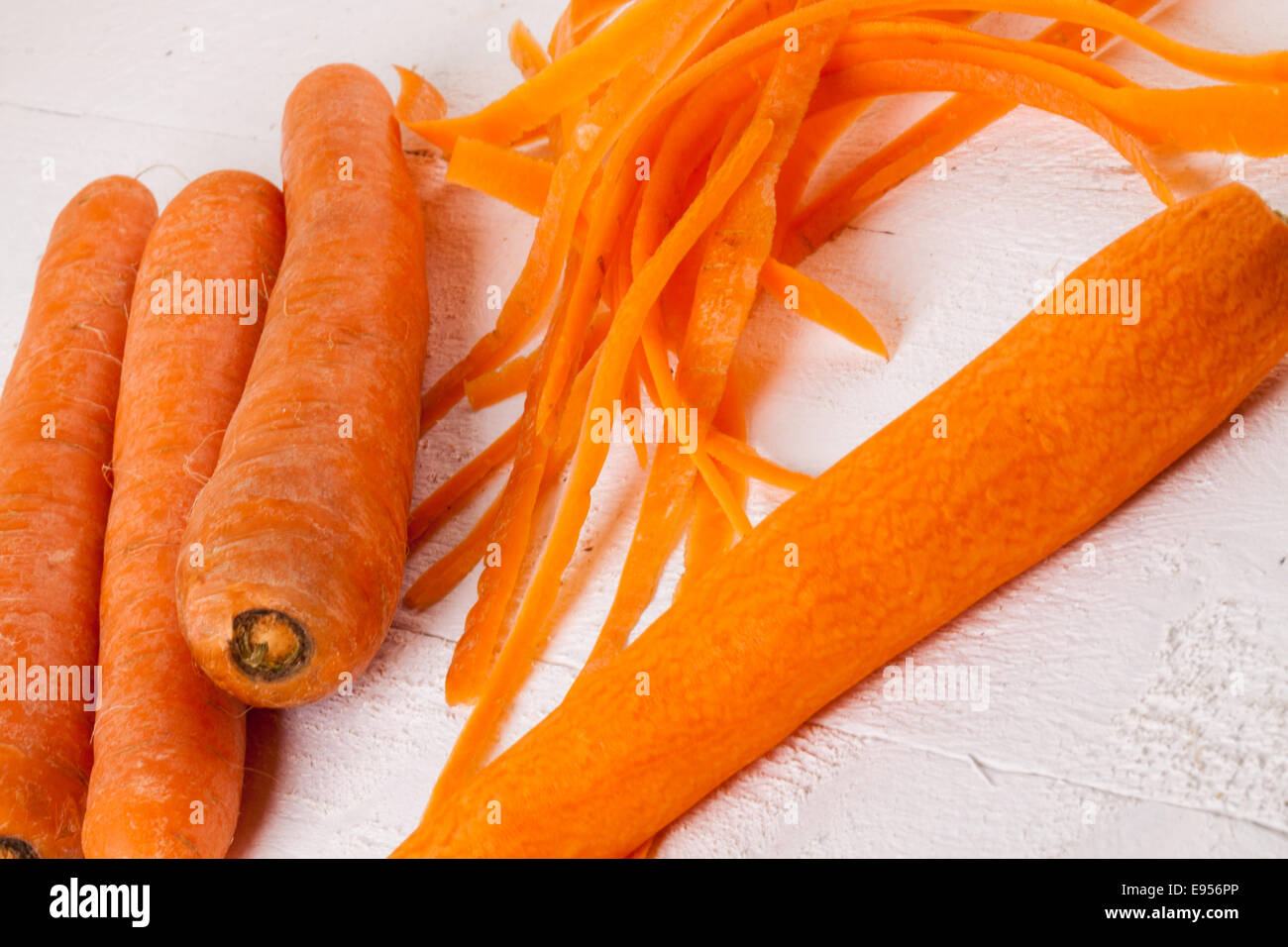 Fresh peeled carrots sliced into thin batons for carrot julienne with a ...